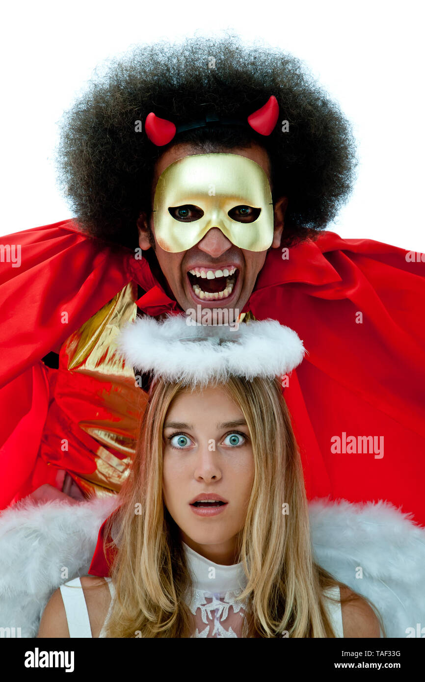 scary devil figure and surprised angel figure together Stock Photo - Alamy