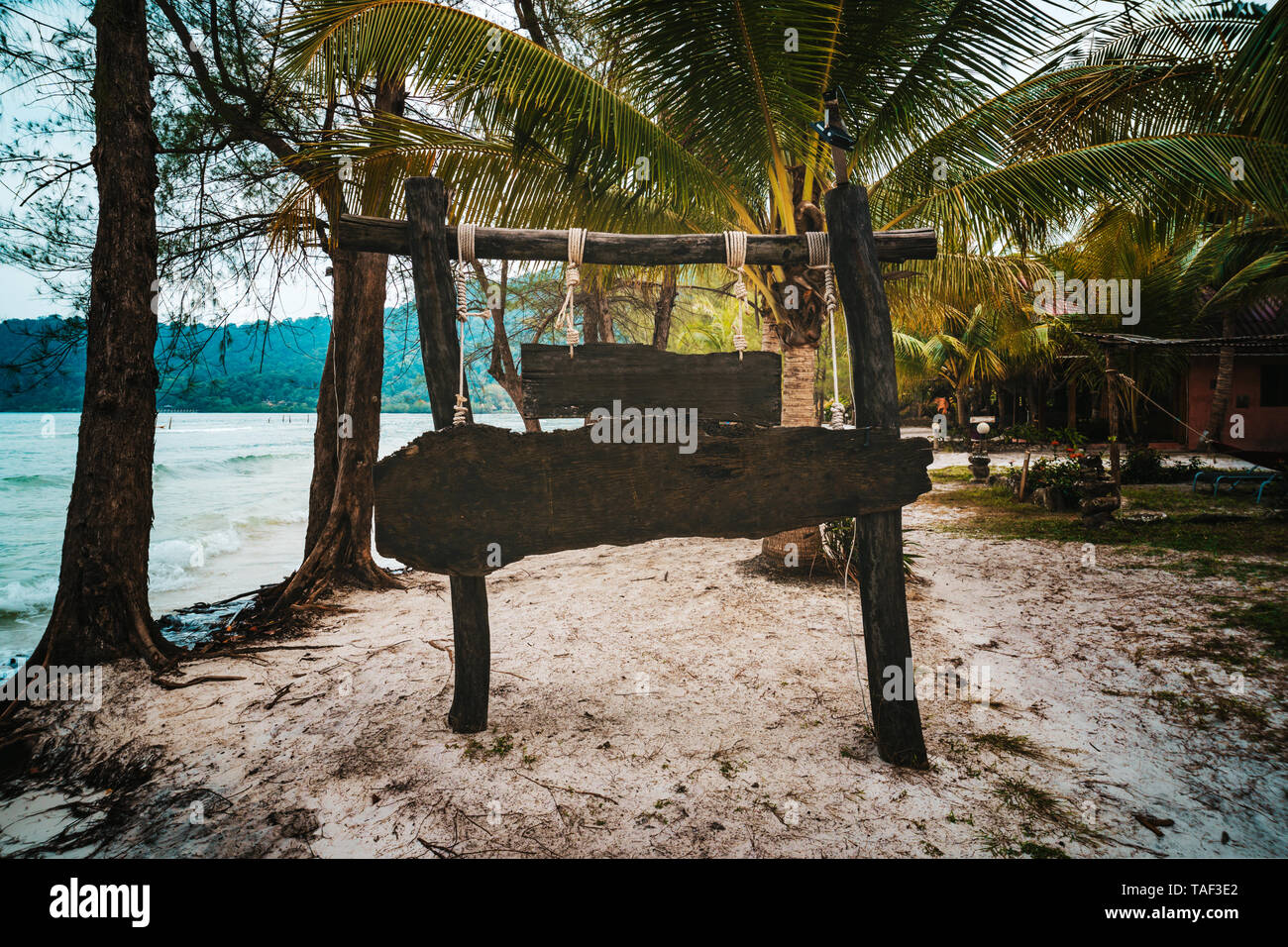wooden signboard on tropical beach. A sign board for the name of the ...