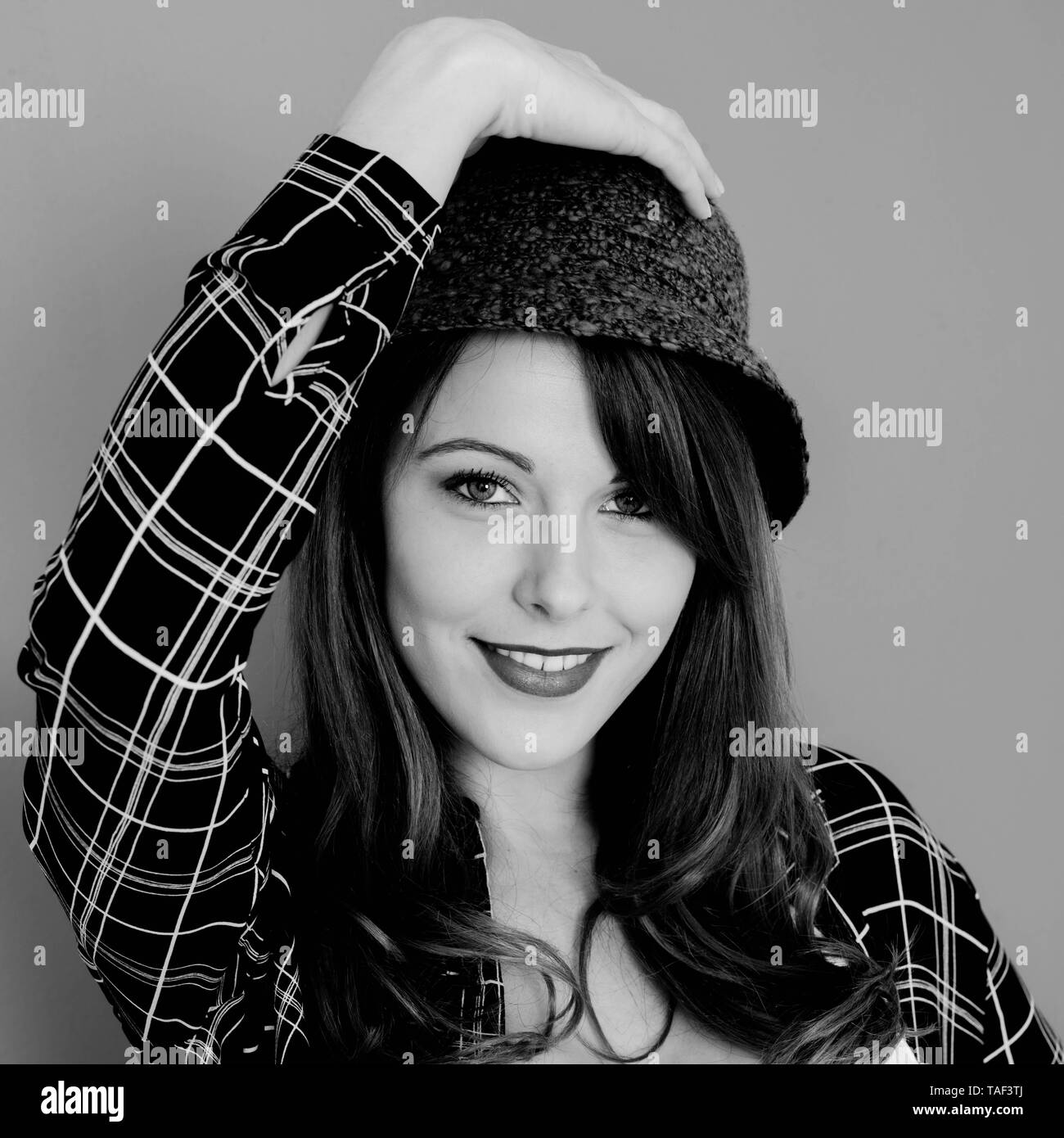 Black and White Portrait of a Young Woman Wearing a Checked Shirt and a ...