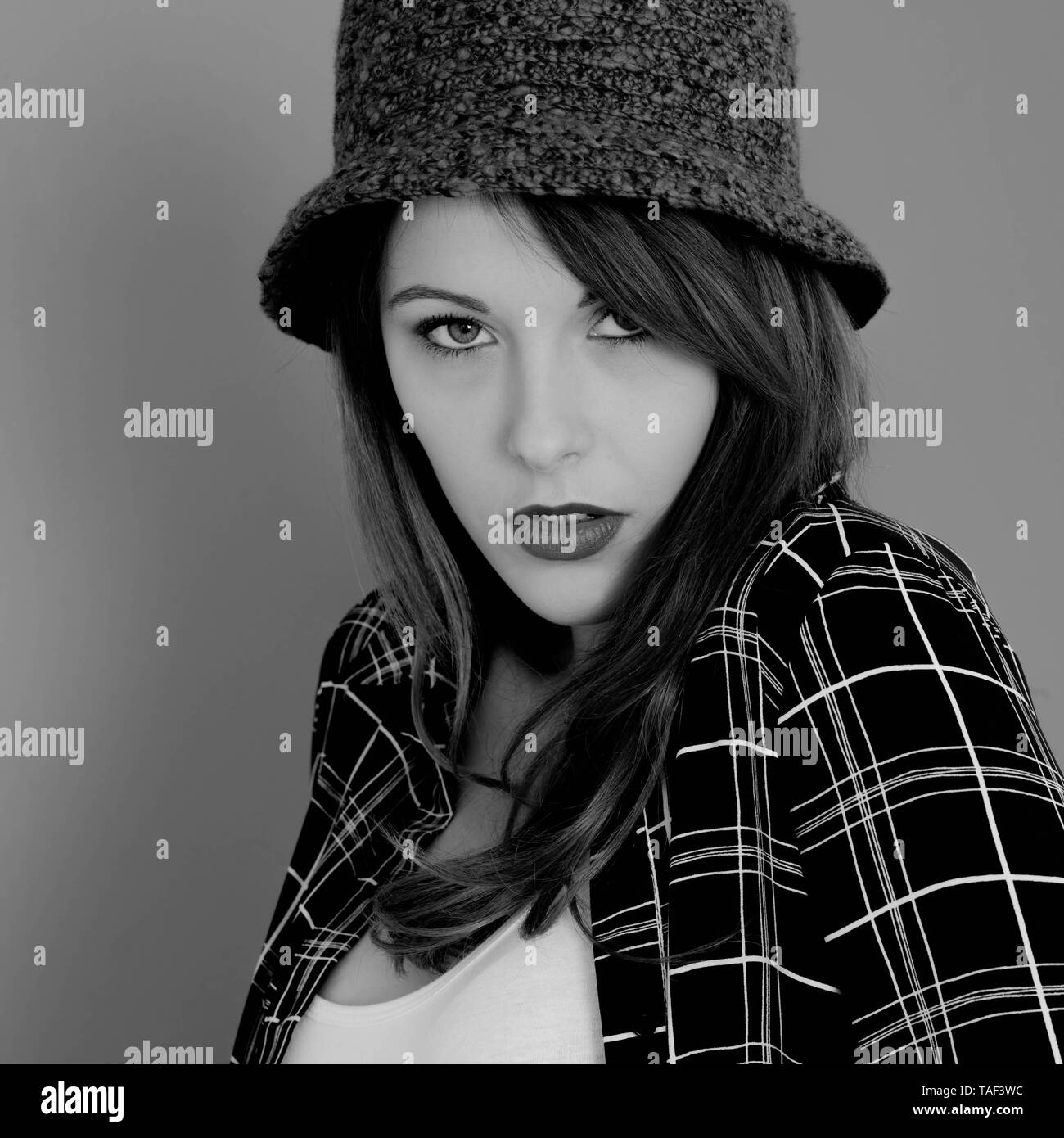 Black and White Portrait of a Young Woman Wearing a Checked Shirt and a ...