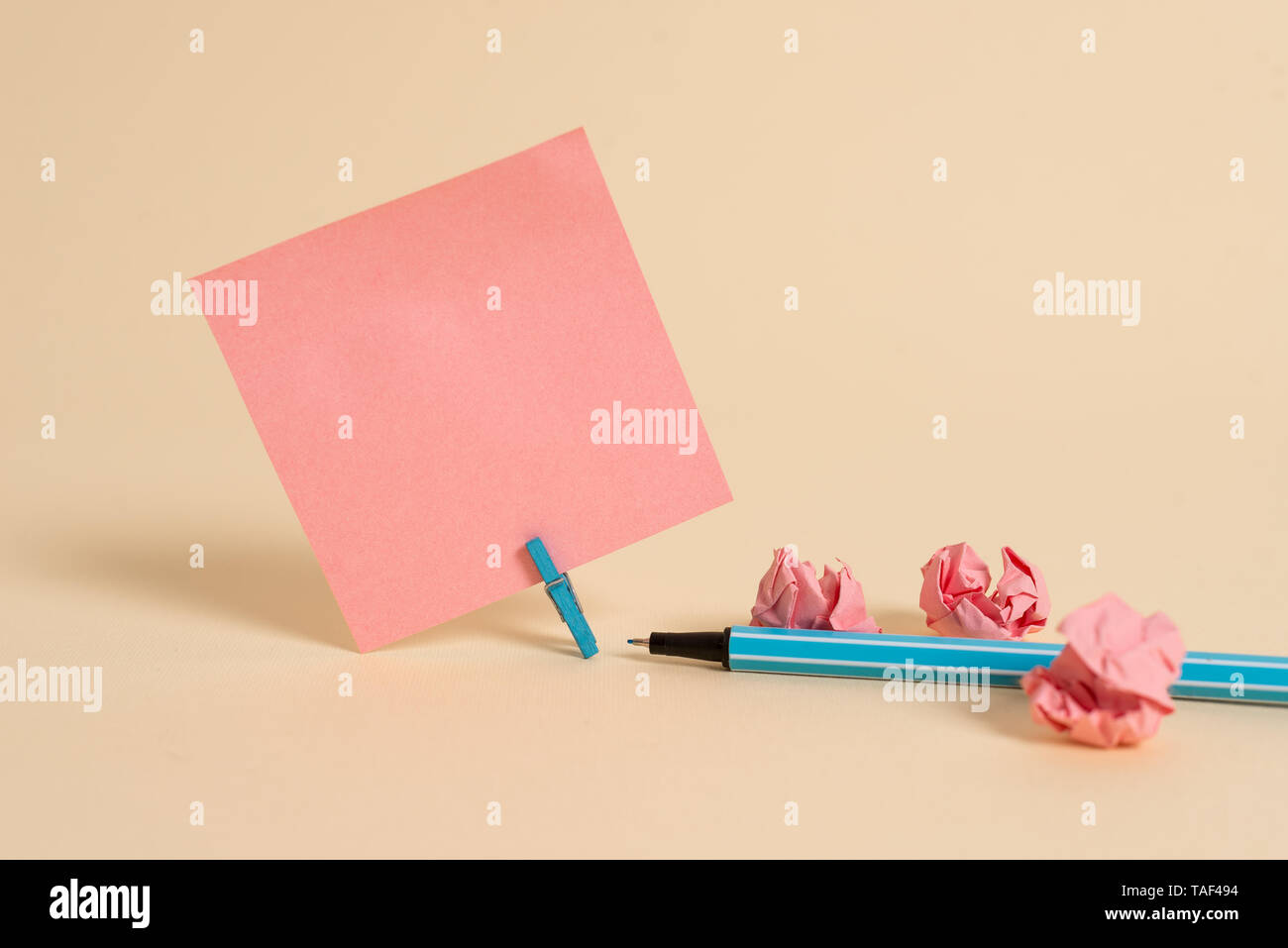 Plain note paper and stationary placed above soft pastel colour ...