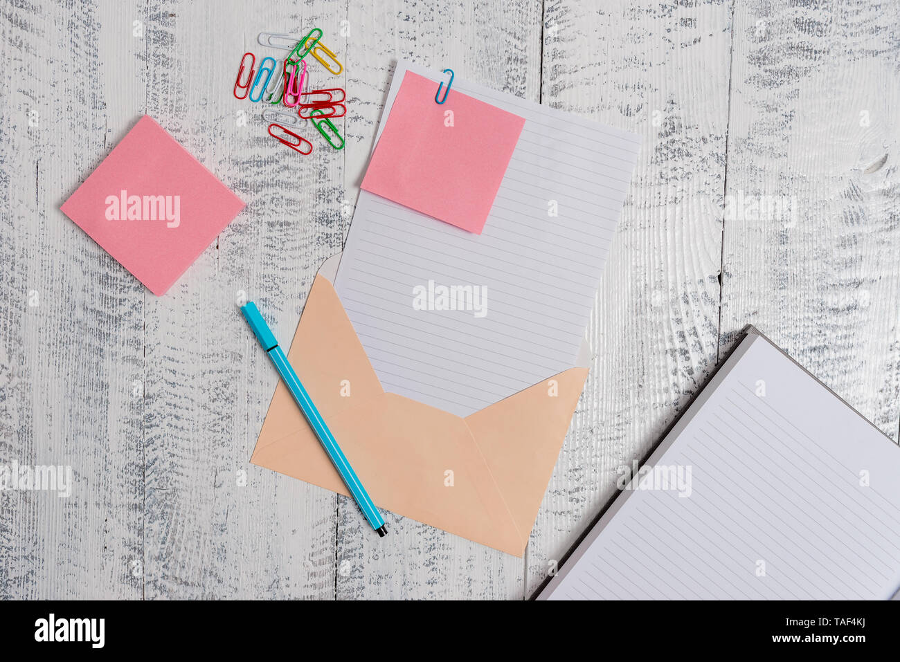 Envelope sheet paper sticky notes ballpoint notepad clips wooden ...