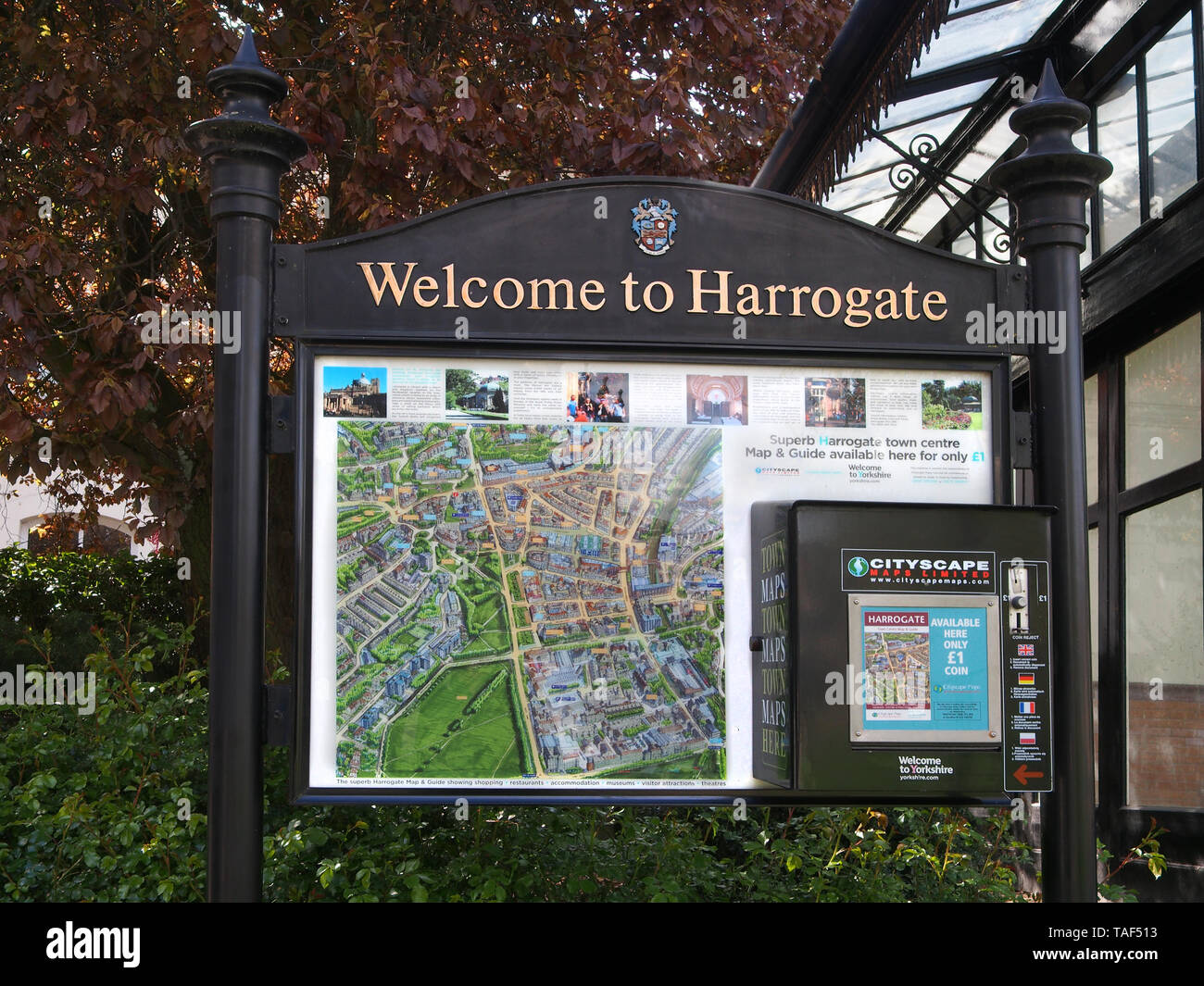 Street sign with a map of Harrogate and a Vending machine which also ...