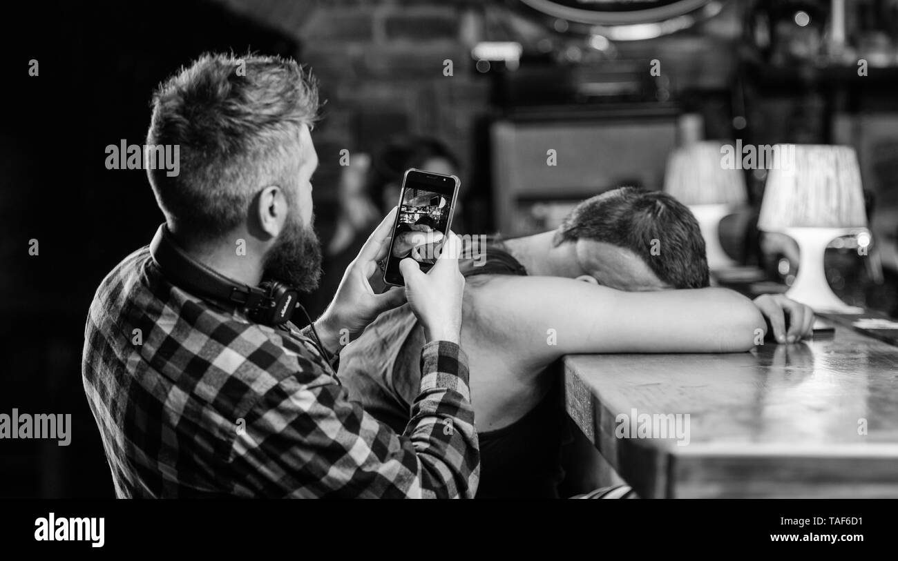 Man drunk fall asleep and guy with smartphone. Hipster taking photo ...
