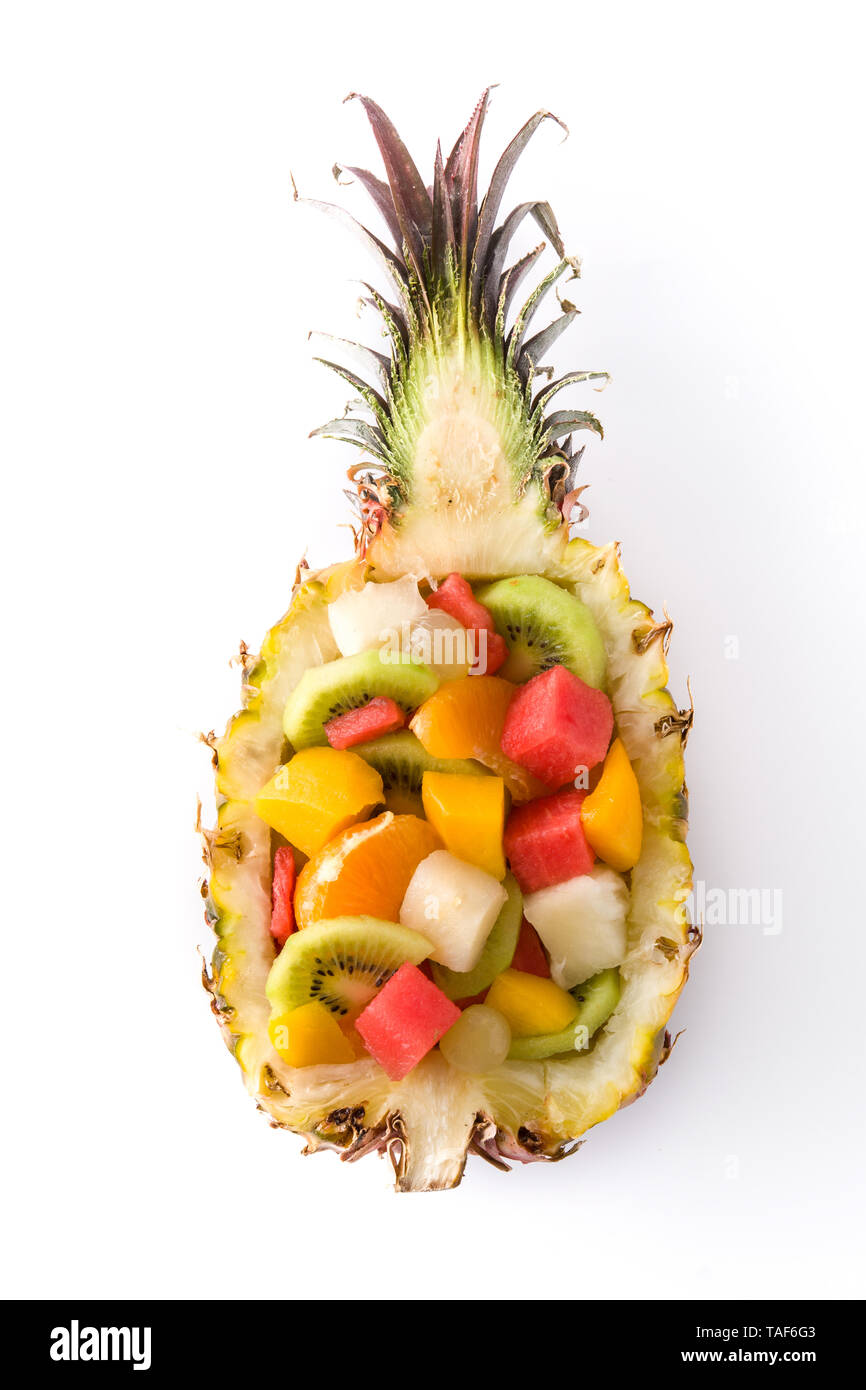 Mix fruit served inside pineapple isolated on white background. Top ...