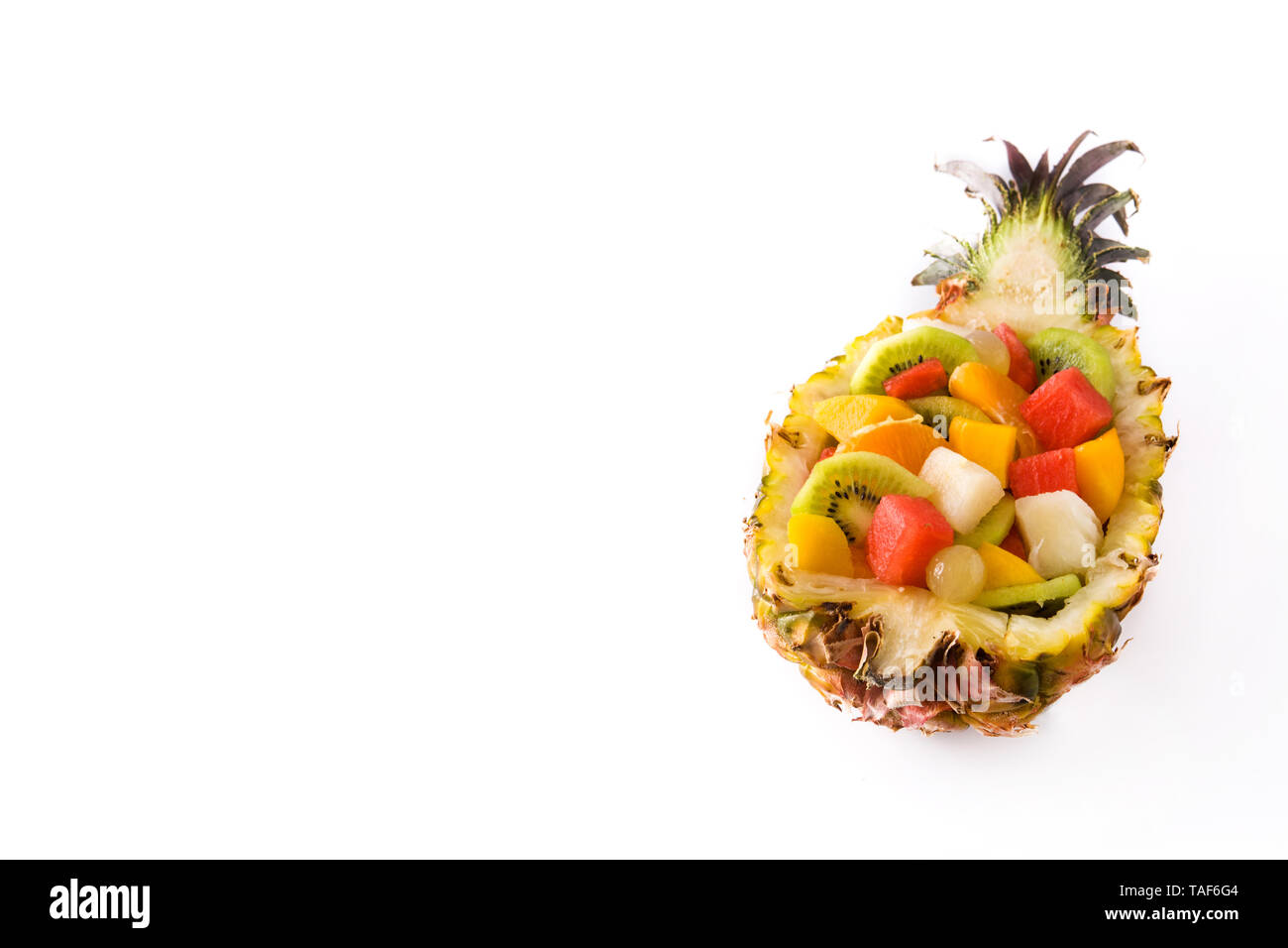 Mix fruit served inside pineapple isolated on white background ...