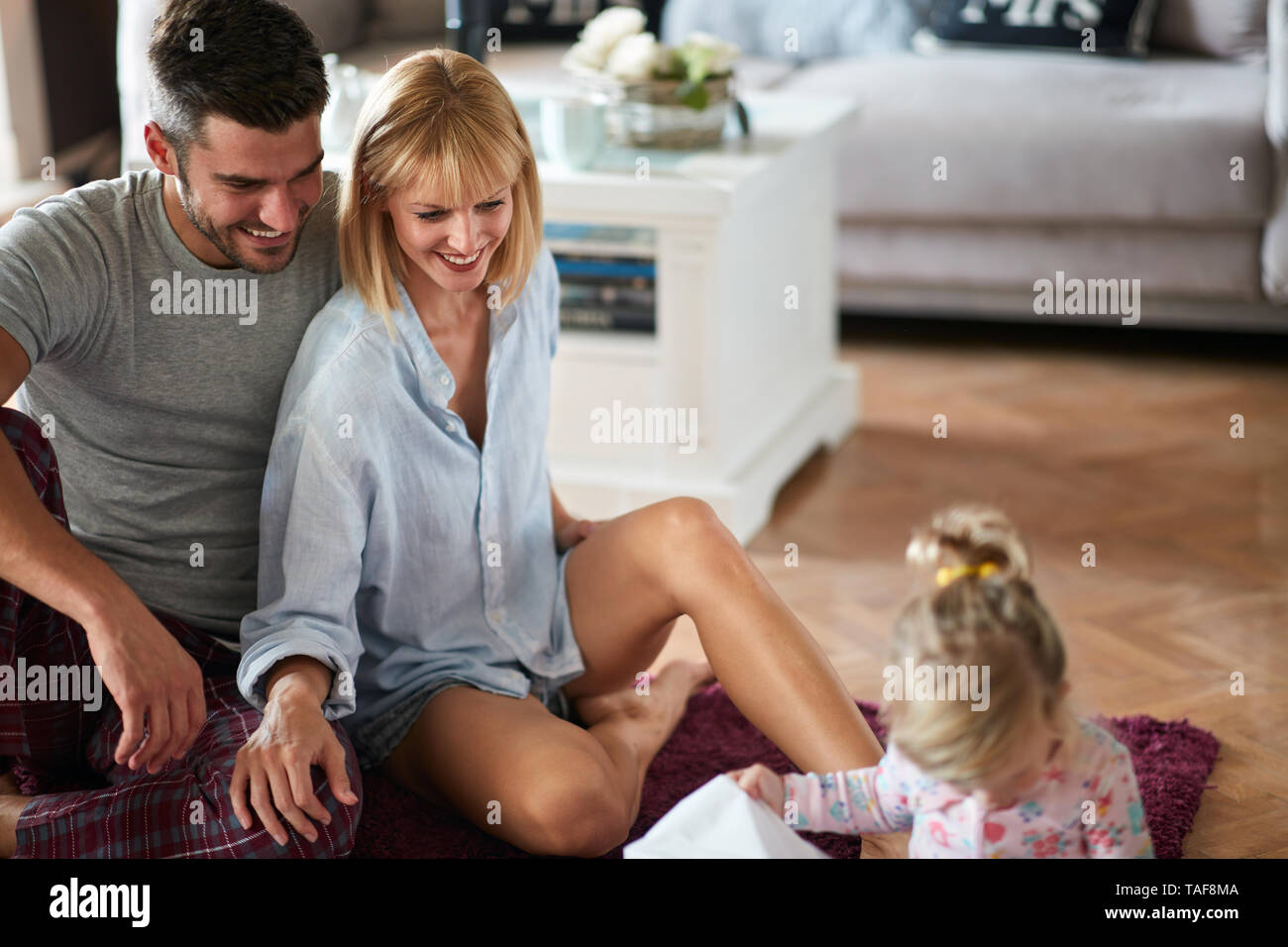 Happy parents enjoying while looking there's little child Stock Photo ...