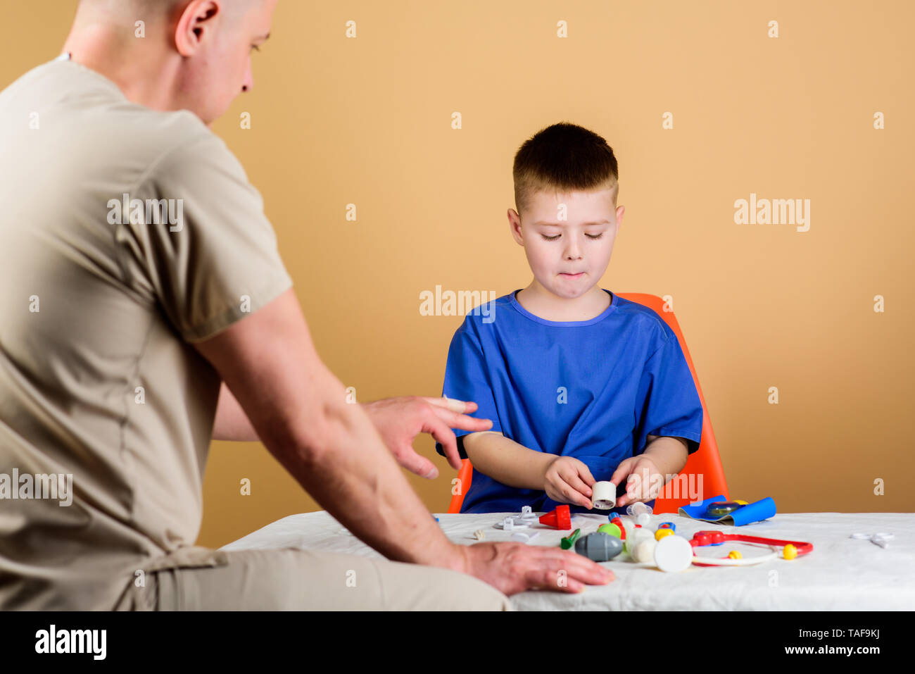 Hospital worker. Medical service. Kid little doctor sit table medical ...