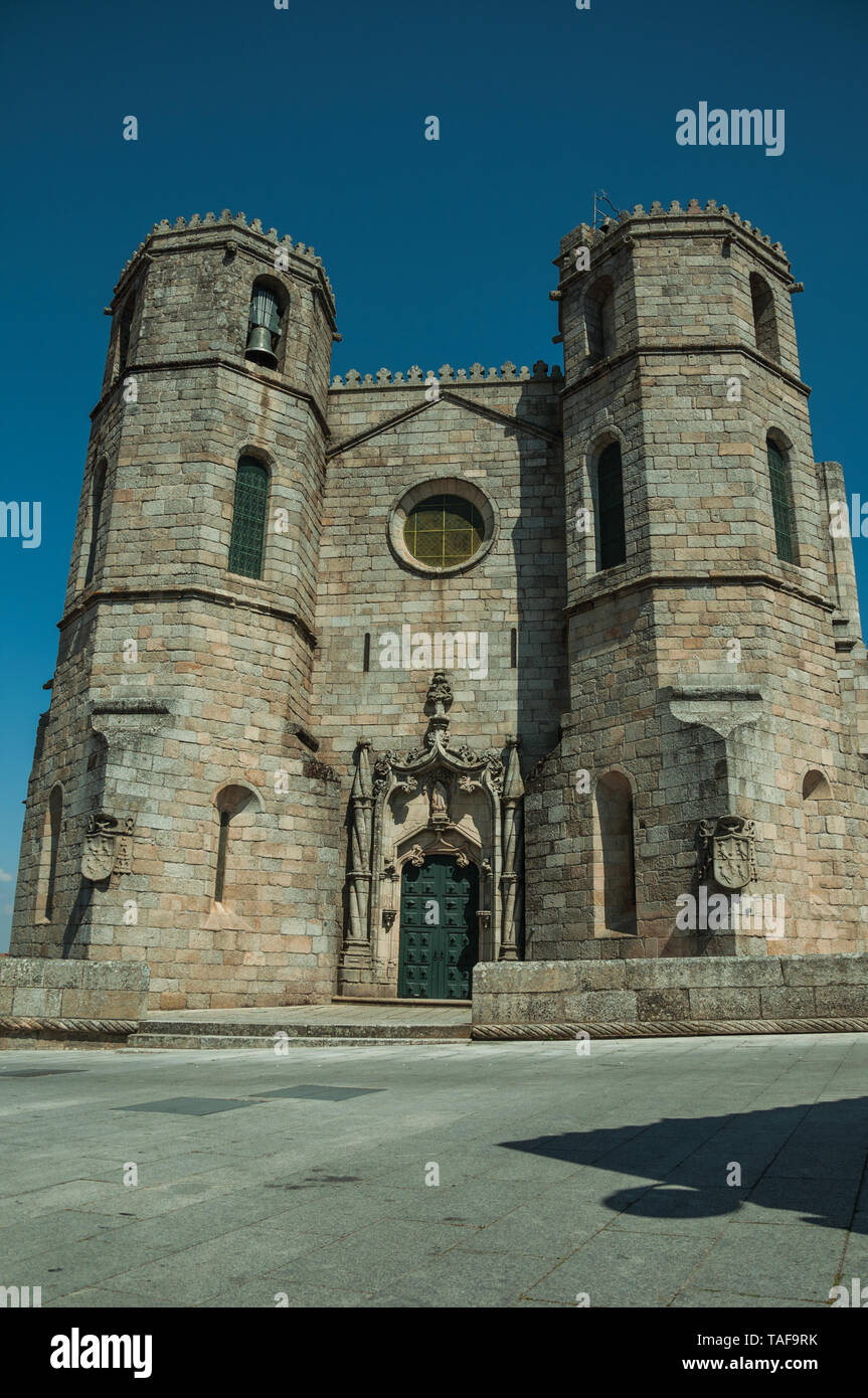 Gothic facade with steeples and decorated door on a sunny day at the ...