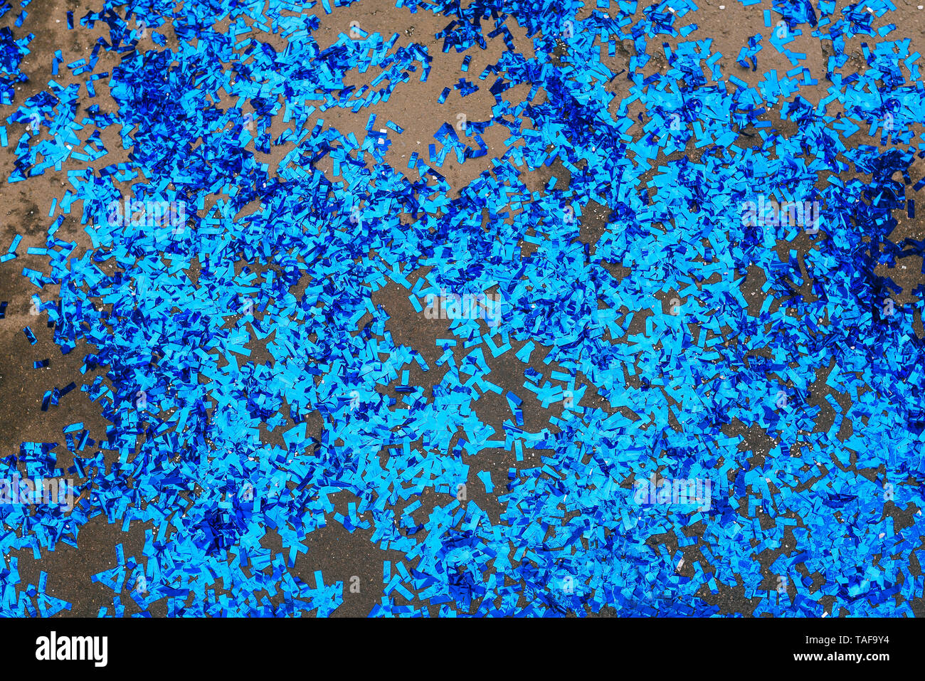 Blue confetti on asphalt after a holiday, party, carnival. Decorations ...