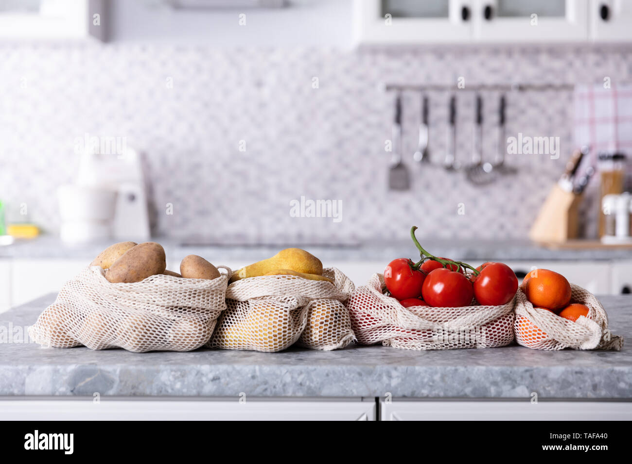 An Overhead View Of Vegetable And Fruits In Net Bag On Kitchen Counter ...