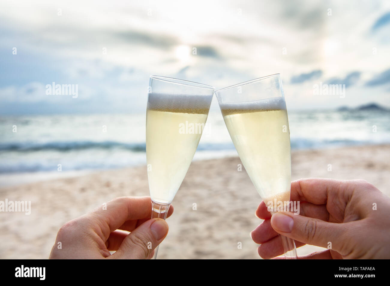 Two champagne glasses clinking hi-res stock photography and images - Alamy