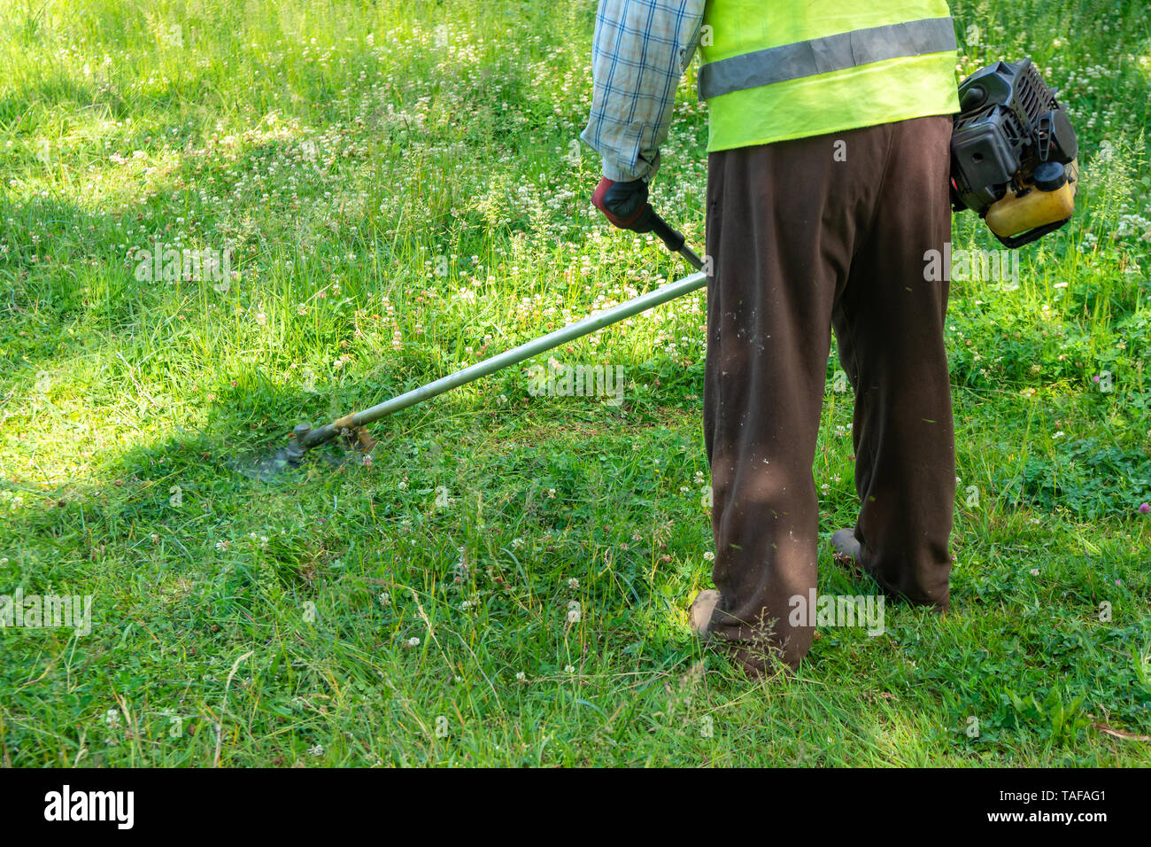 The gardener cutting grass by lawn mower, lawn care. Nature Stock Photo ...
