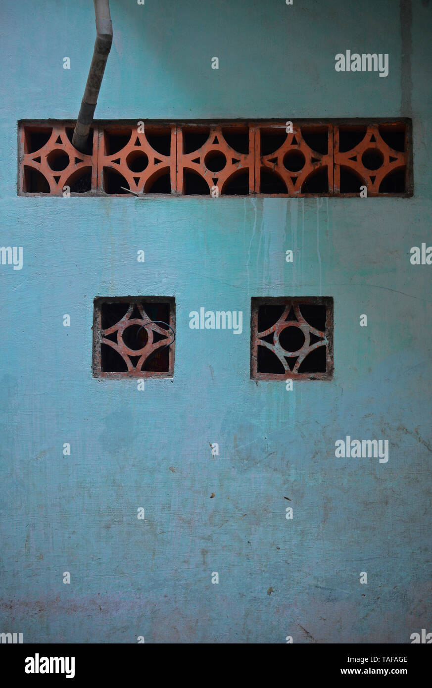 Small ventilation windows in a blue wall near Tran Hung Dao in District ...