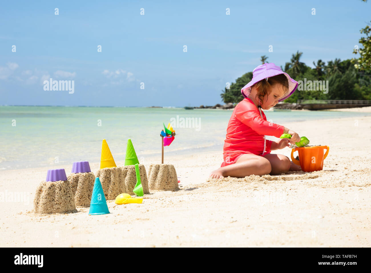 Kid girl blowing windmill hi-res stock photography and images - Alamy