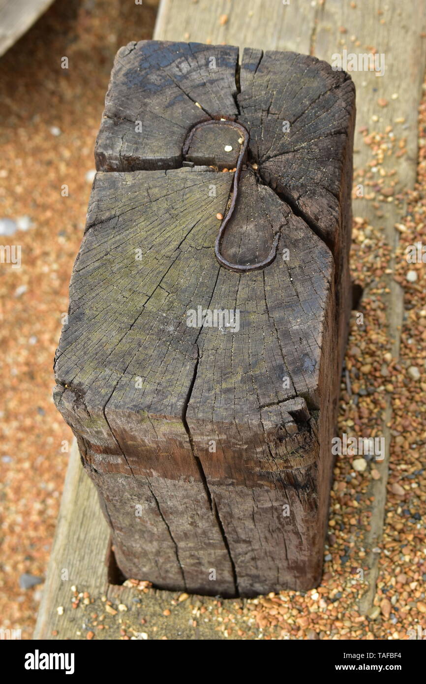 Close up of worn,wooden post, part of the groyne division on the beach ...