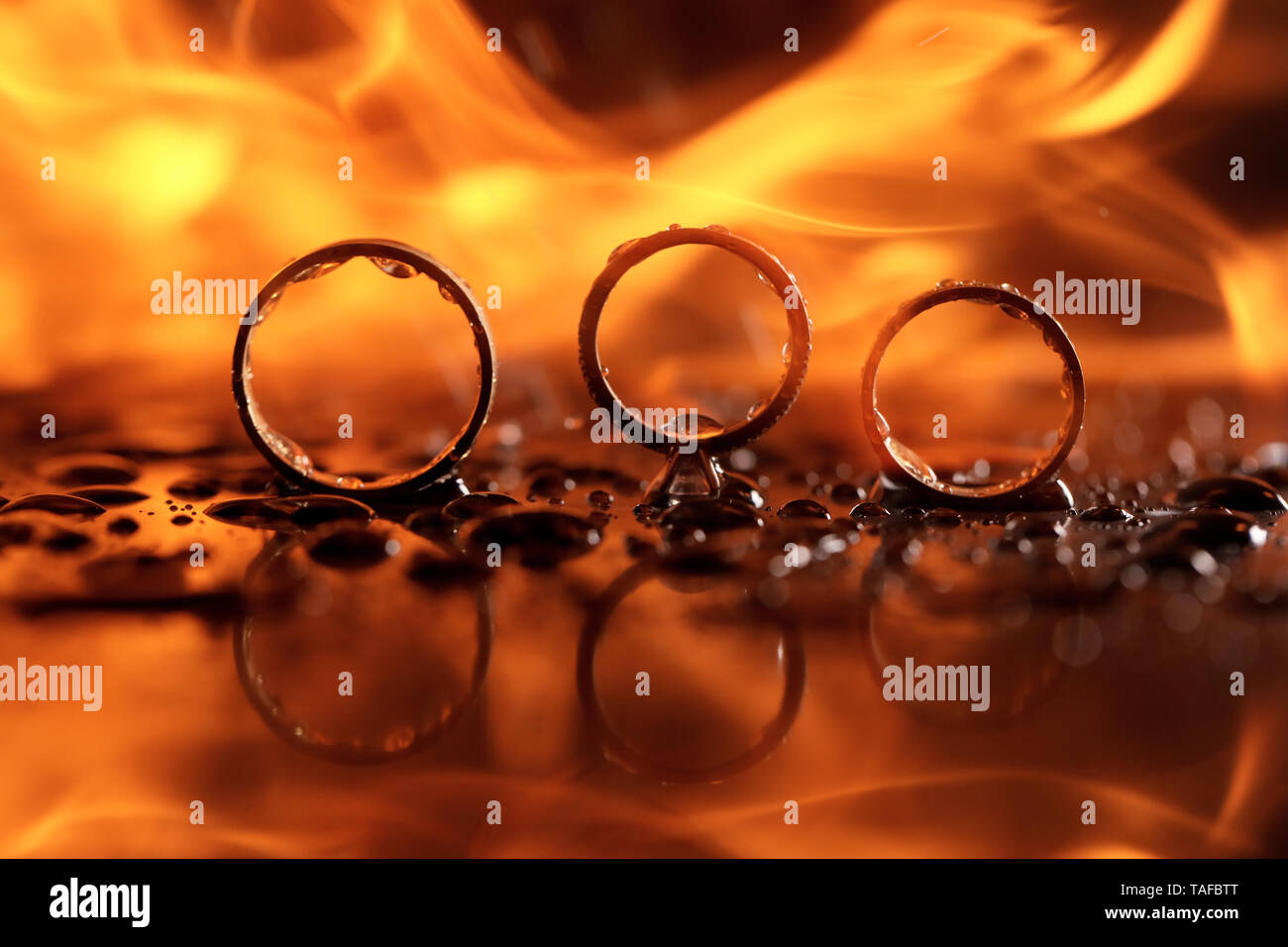 beautiful wedding rings on fire with reflection and in water Stock ...