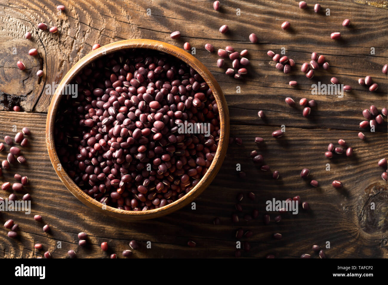 Raw, uncooked, dried adzuki (red mung) beans in wooden bowl on rustic ...