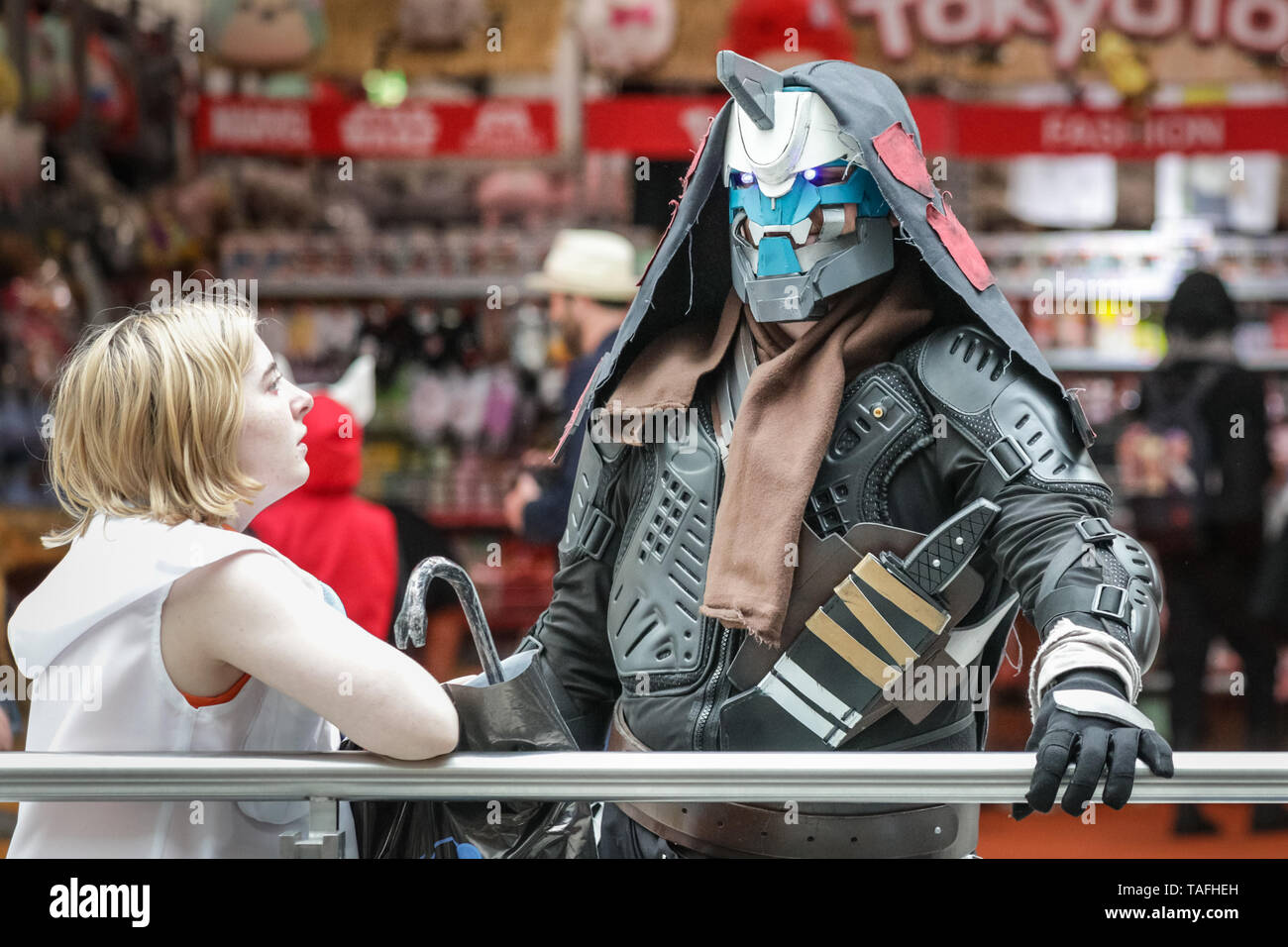 ExCel London, UK - 24th May 2019. A cosplayer chats to his friend in ...