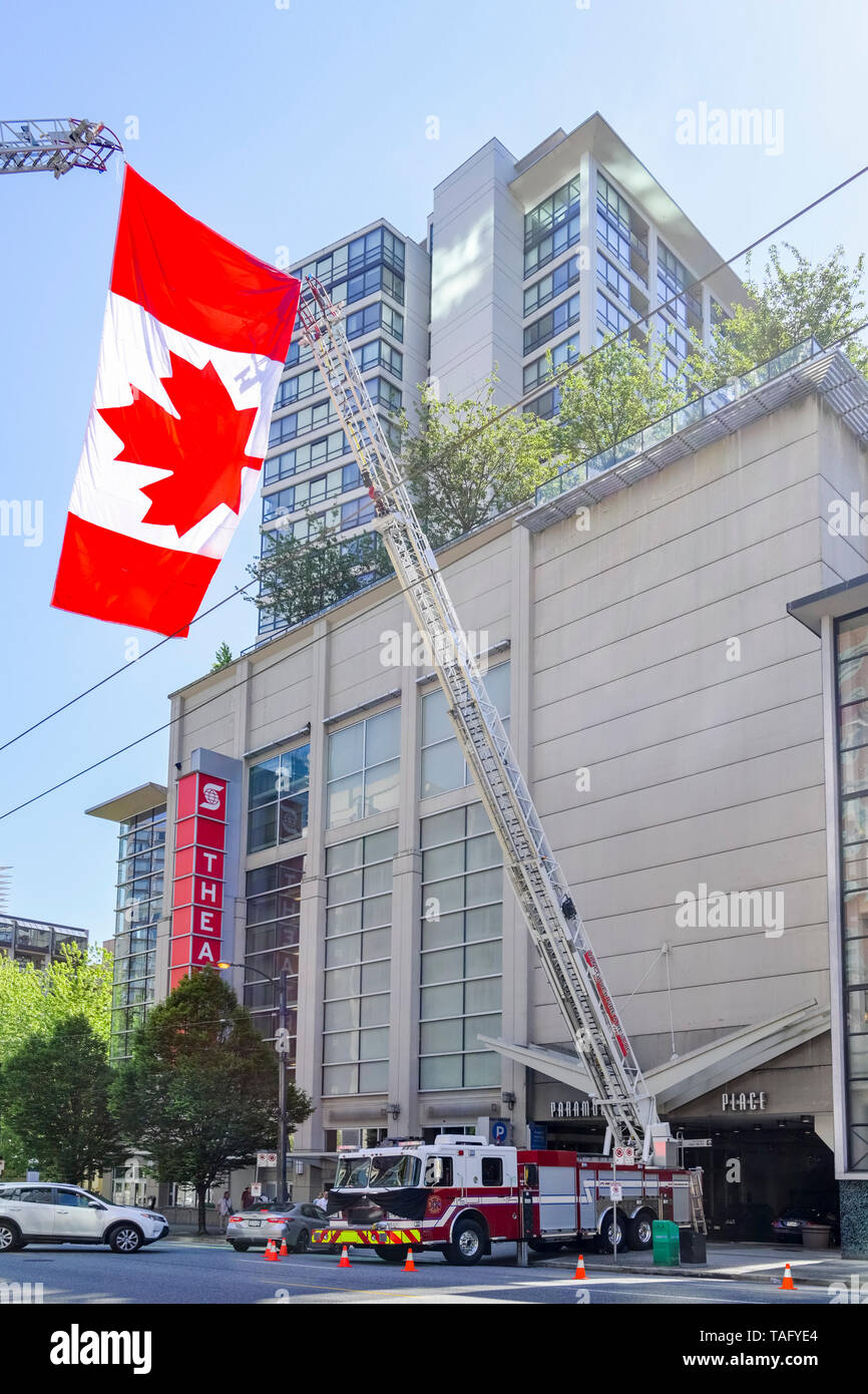 Canadian flag helsd aloft by 2 Fire truck ladders in salute to ...