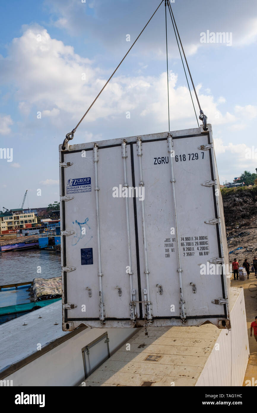 Loading containers on a ferry at Puerto Henry on Amazon River in ...