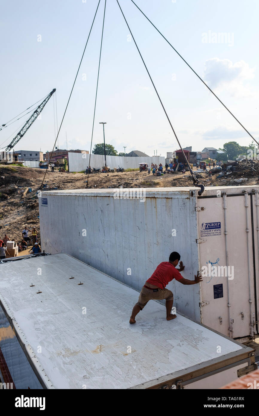 Loading containers on a ferry at Puerto Henry on Amazon River in ...