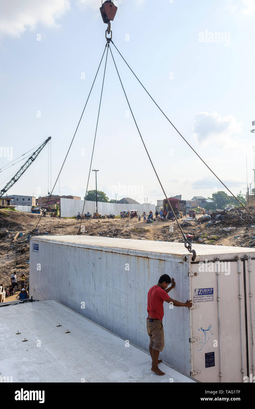 Loading containers on a ferry at Puerto Henry on Amazon River in ...