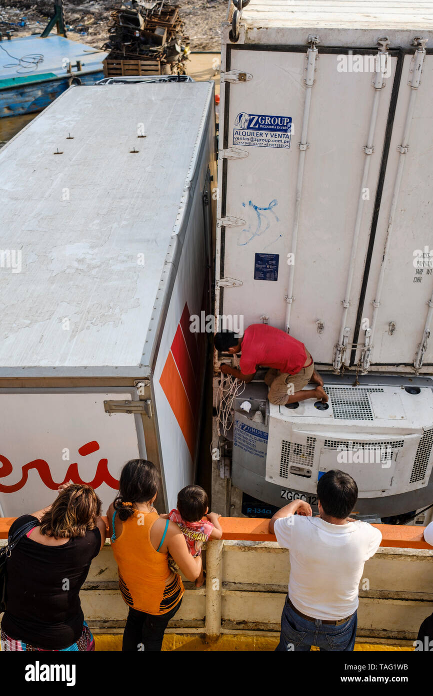 Loading containers on a ferry at Puerto Henry on Amazon River in ...