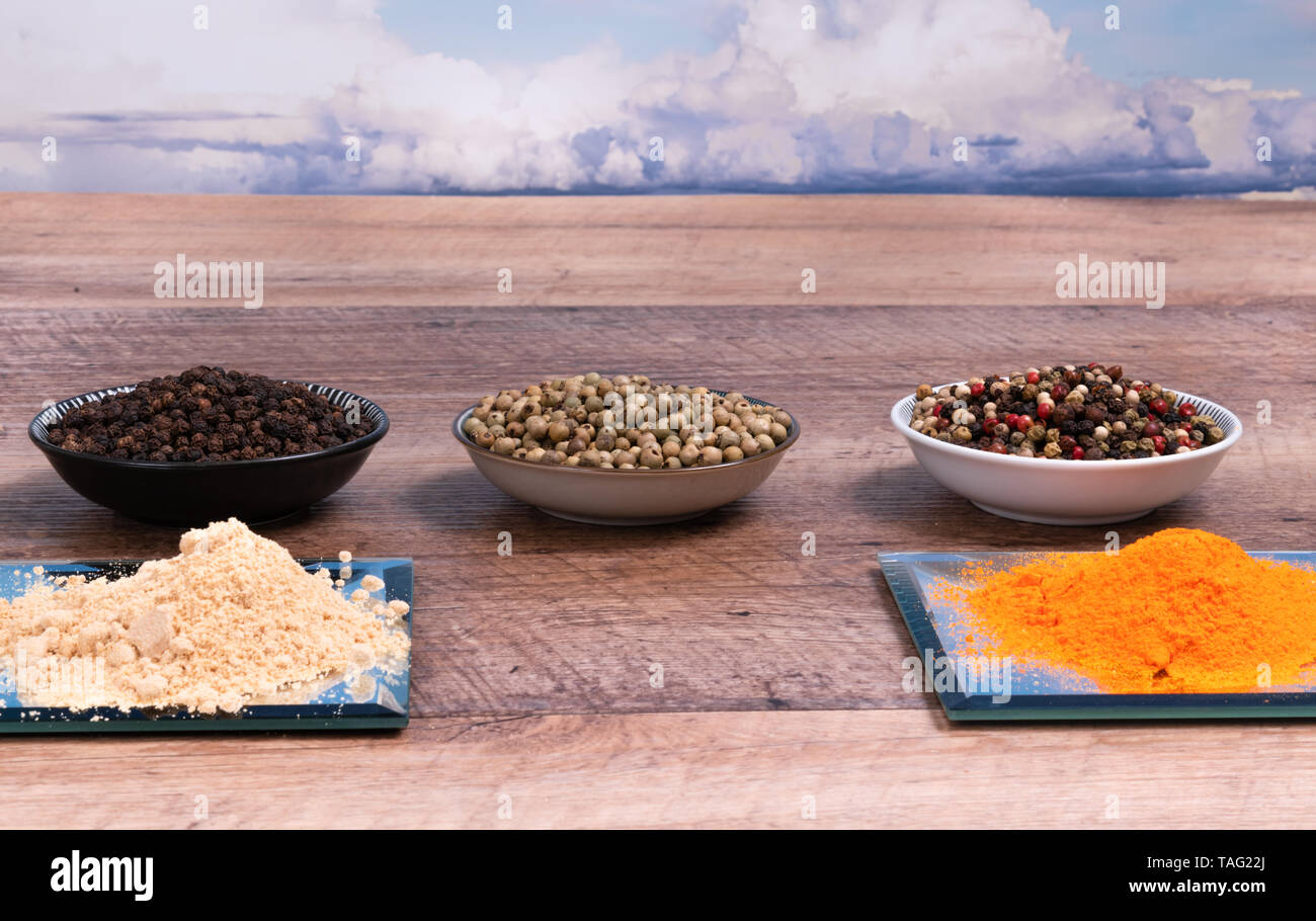 Condiments ground and in grains in bowls Stock Photo - Alamy