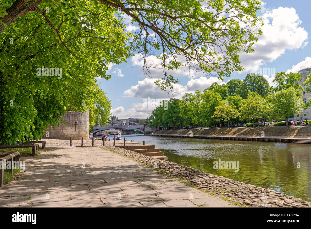 A view of the River Ouse in York in the sunshine. A cobbled landing ...
