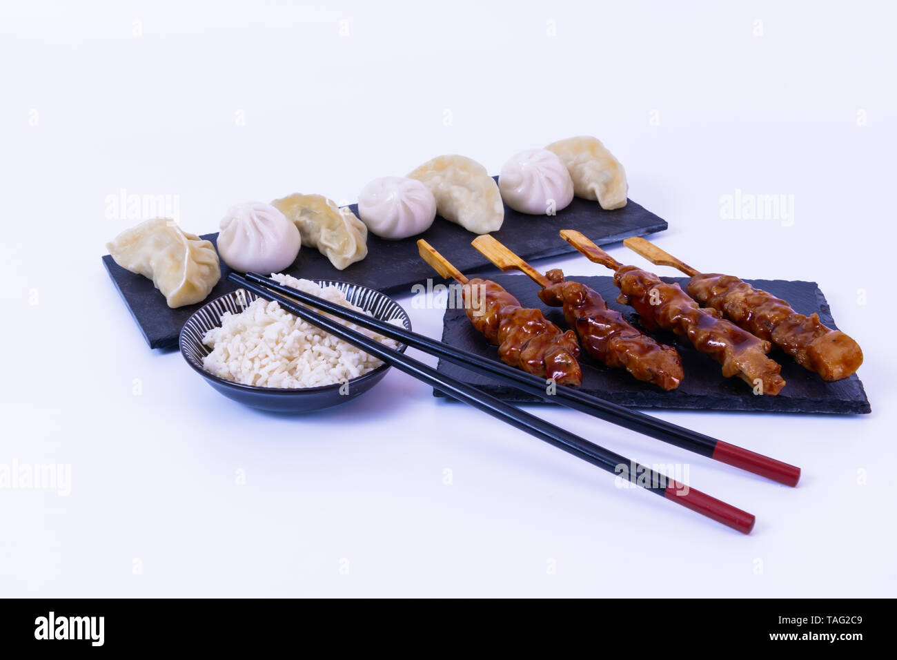 dumplings, white rice and sushi rolls. White background Stock Photo - Alamy