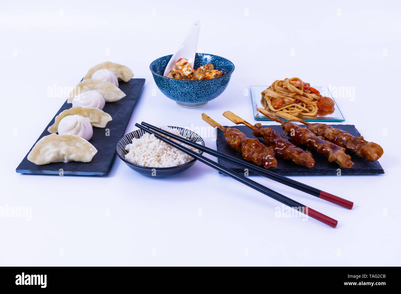 dumplings, white rice and sushi rolls. White background Stock Photo - Alamy