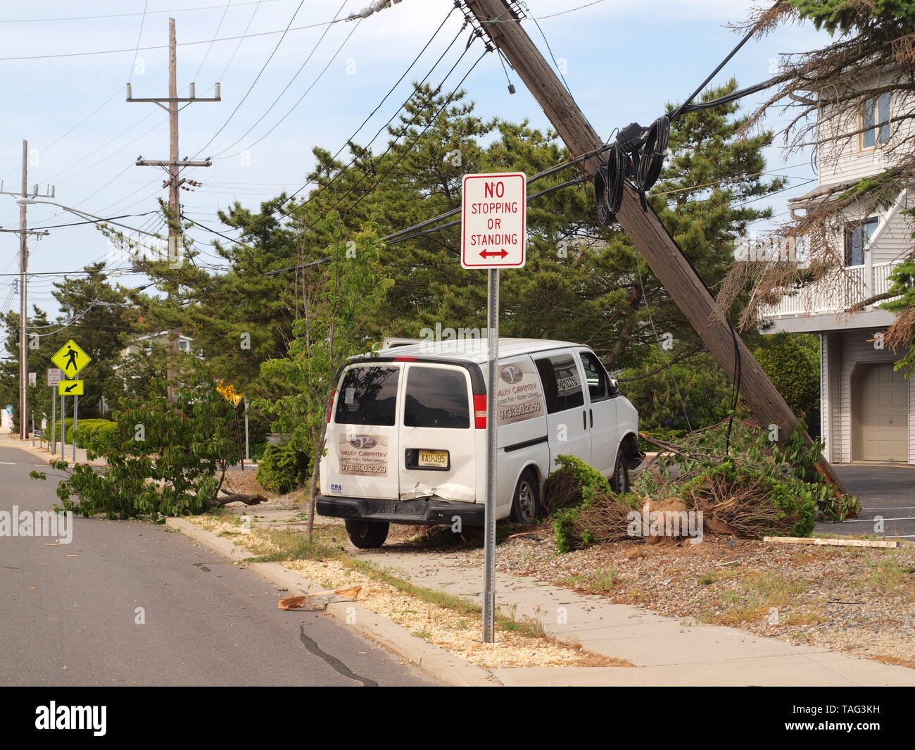 Aftermath of a van collision with a utility pole on a New Jersey ...