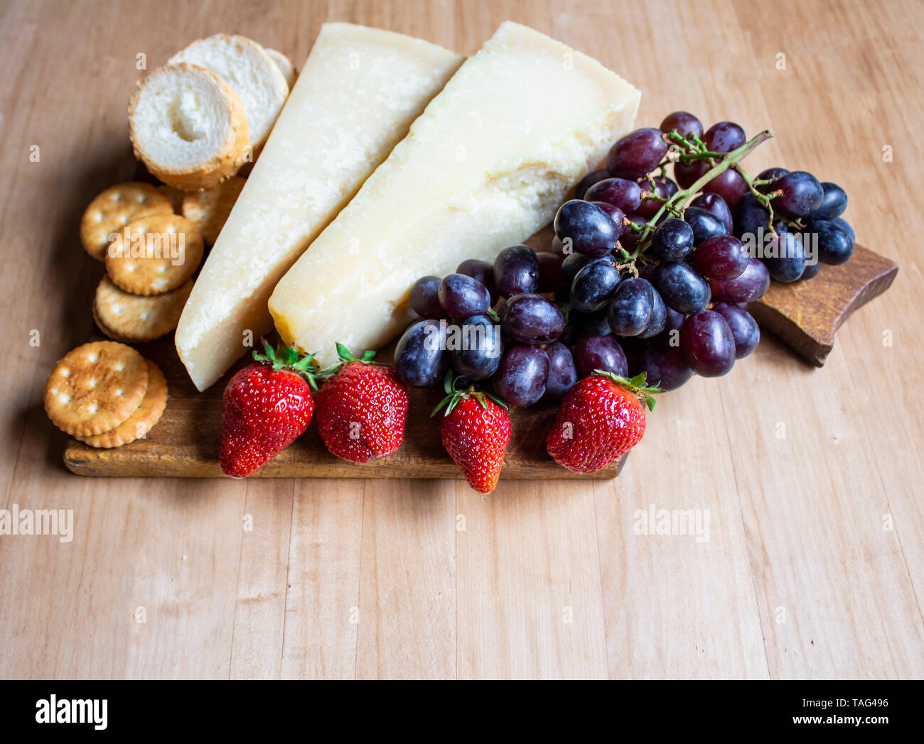 Cheese with grapes and strawberries, cracker, nuts, fruits and nuts ...