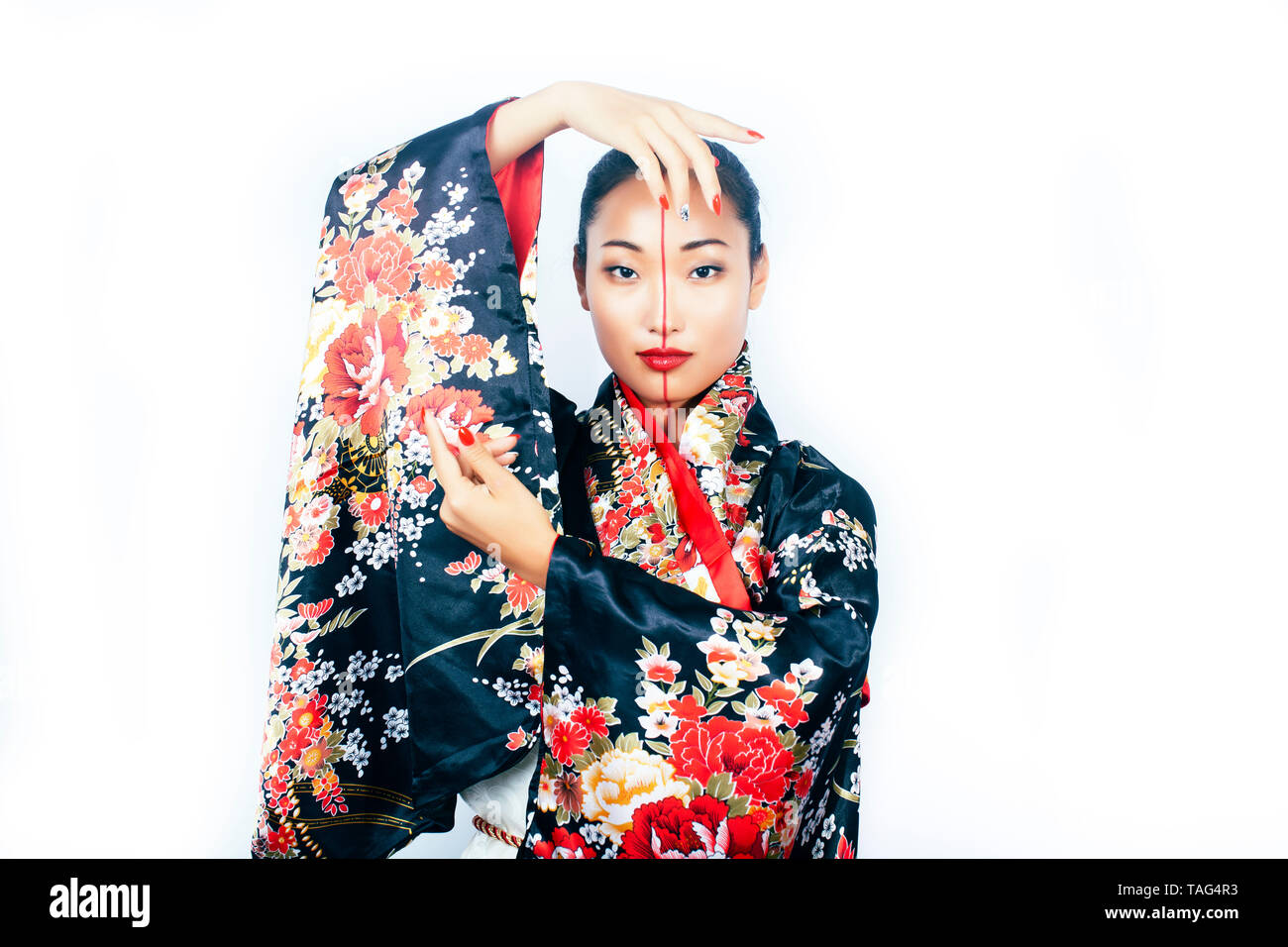 young pretty real geisha in kimono with sakura and decoration on white ...