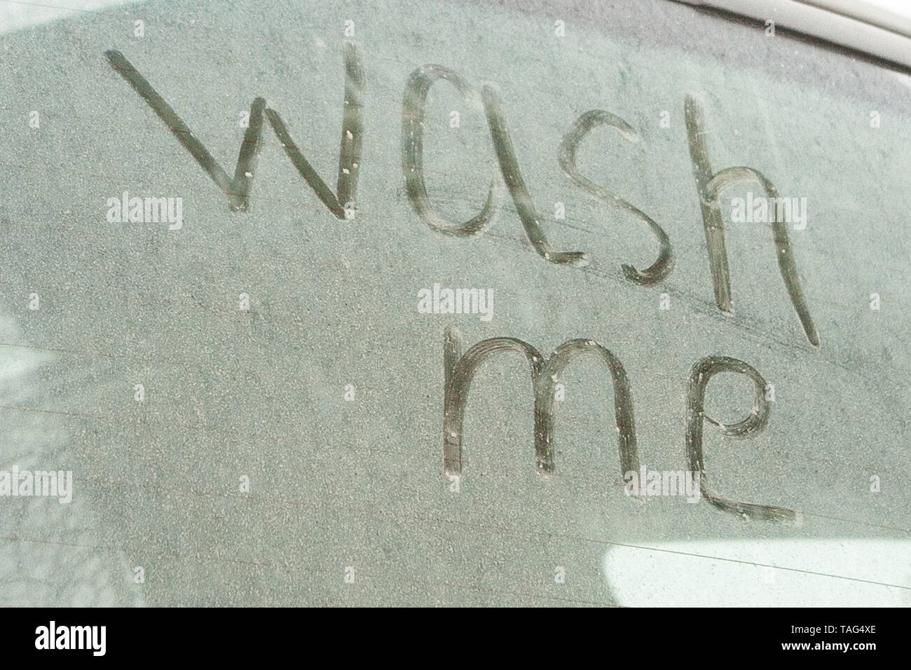 Write the words wash me on the very dirty surface of the car. Concept ...