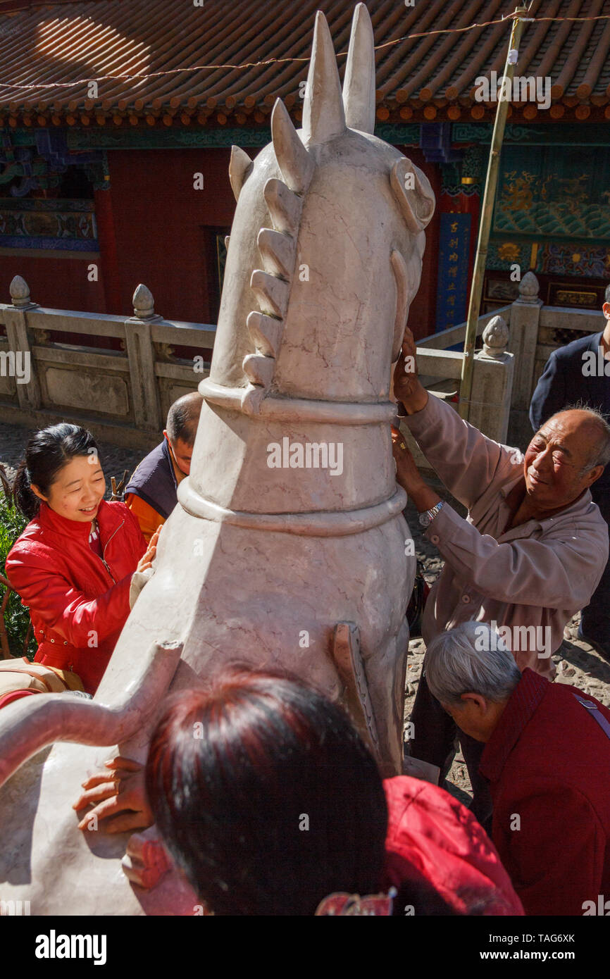 People touch marble dragon for good luck in Buddhist temple Stock Photo ...