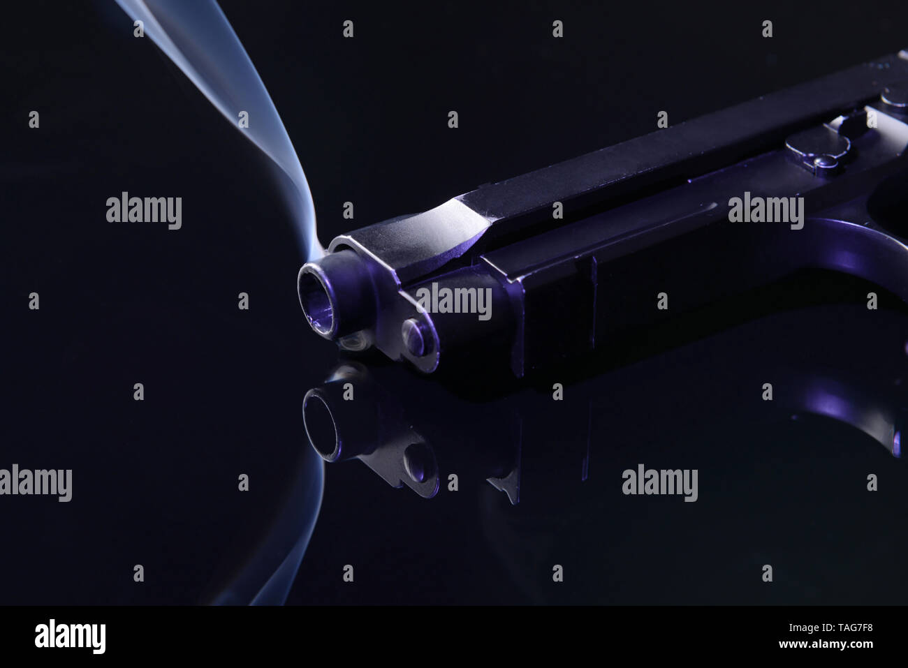 Smoking gun on dark background Stock Photo - Alamy