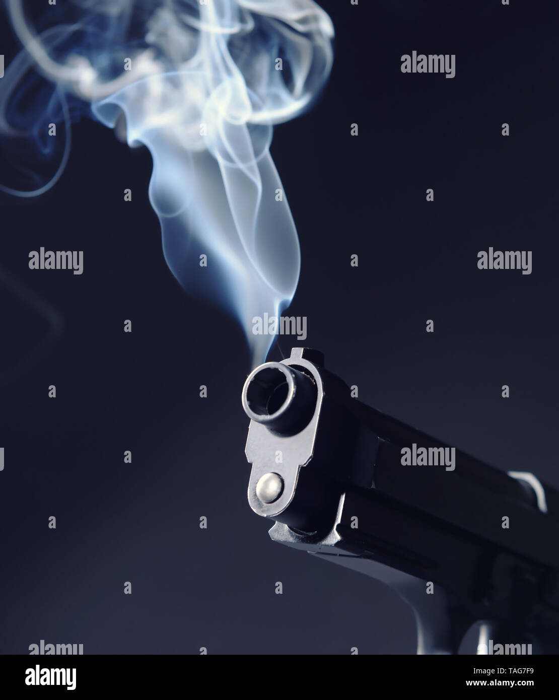 Smoking gun on dark background Stock Photo - Alamy