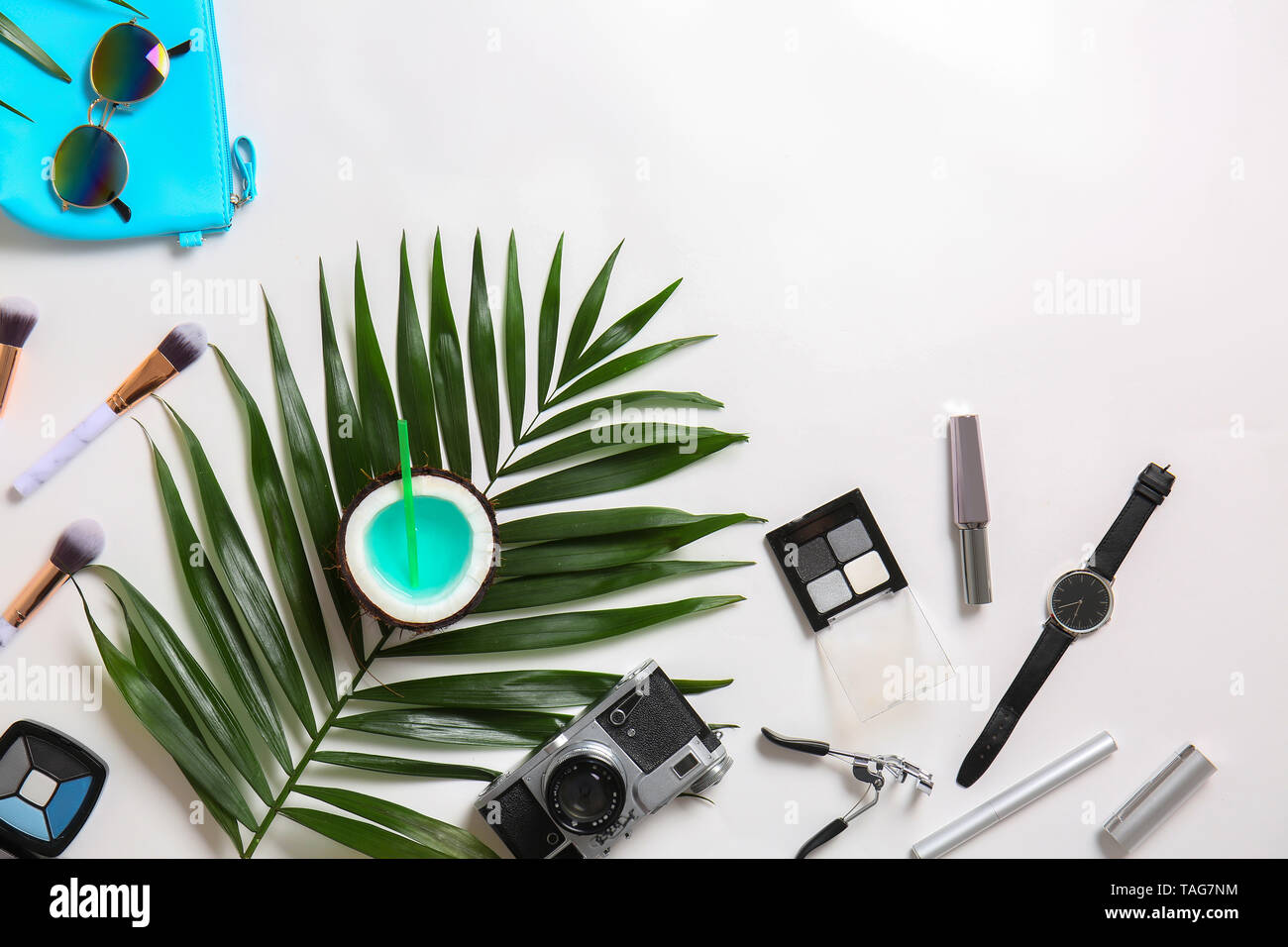 Composition with female items and photo camera on white background ...