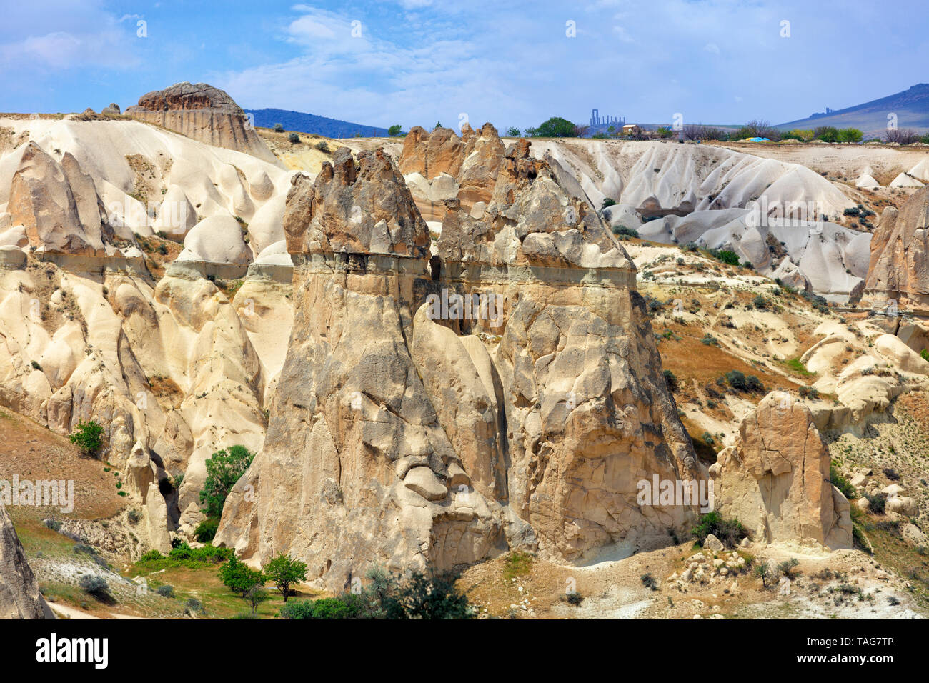 Red and white sandstone cliffs, ancient caves in a mountain landscape ...