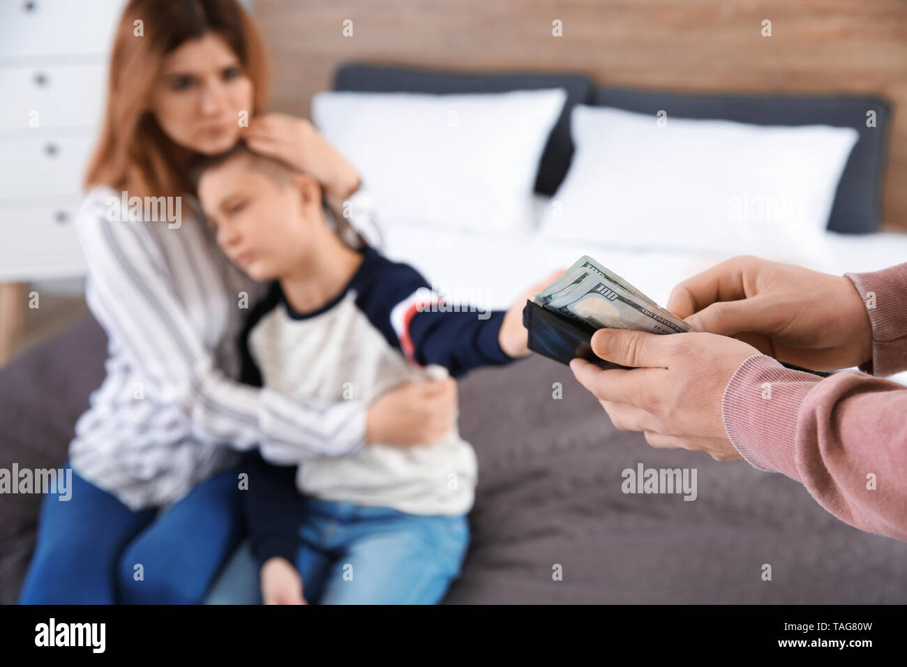 Man giving alimony to his ex-family at home Stock Photo - Alamy