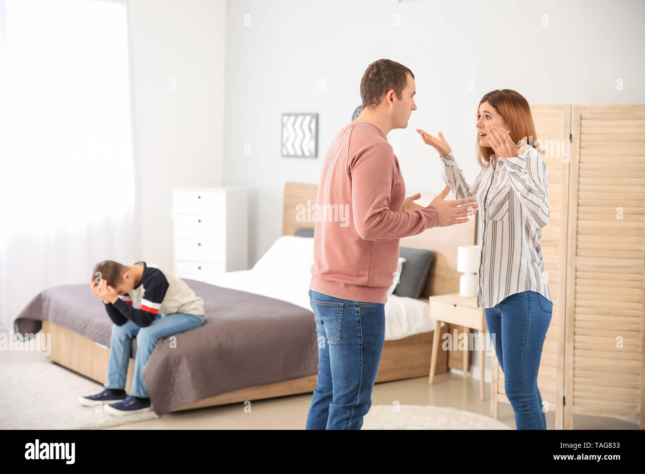 Sad little boy with his quarreling parents at home Stock Photo - Alamy