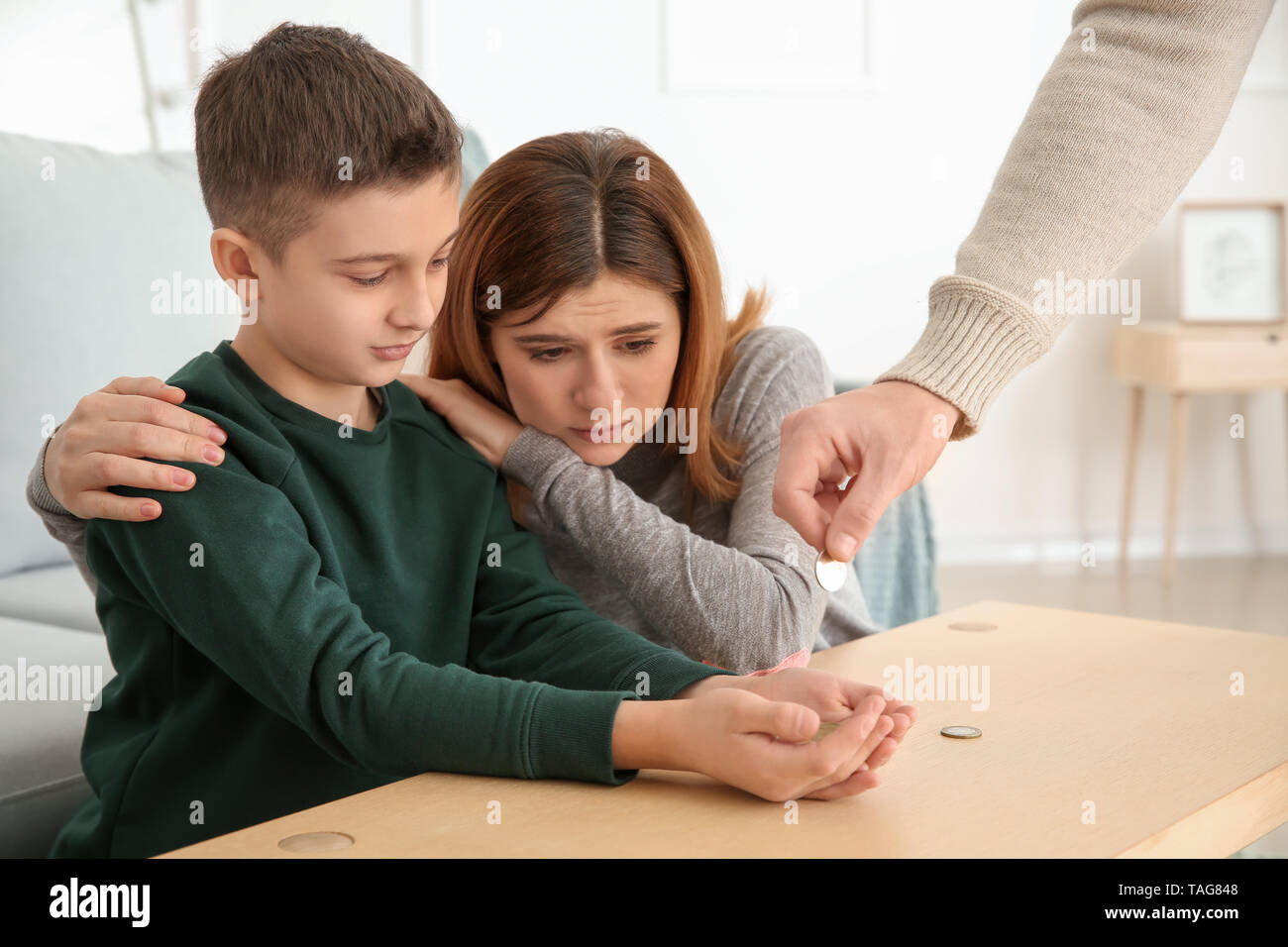 Man giving alimony to his ex-family at home Stock Photo - Alamy