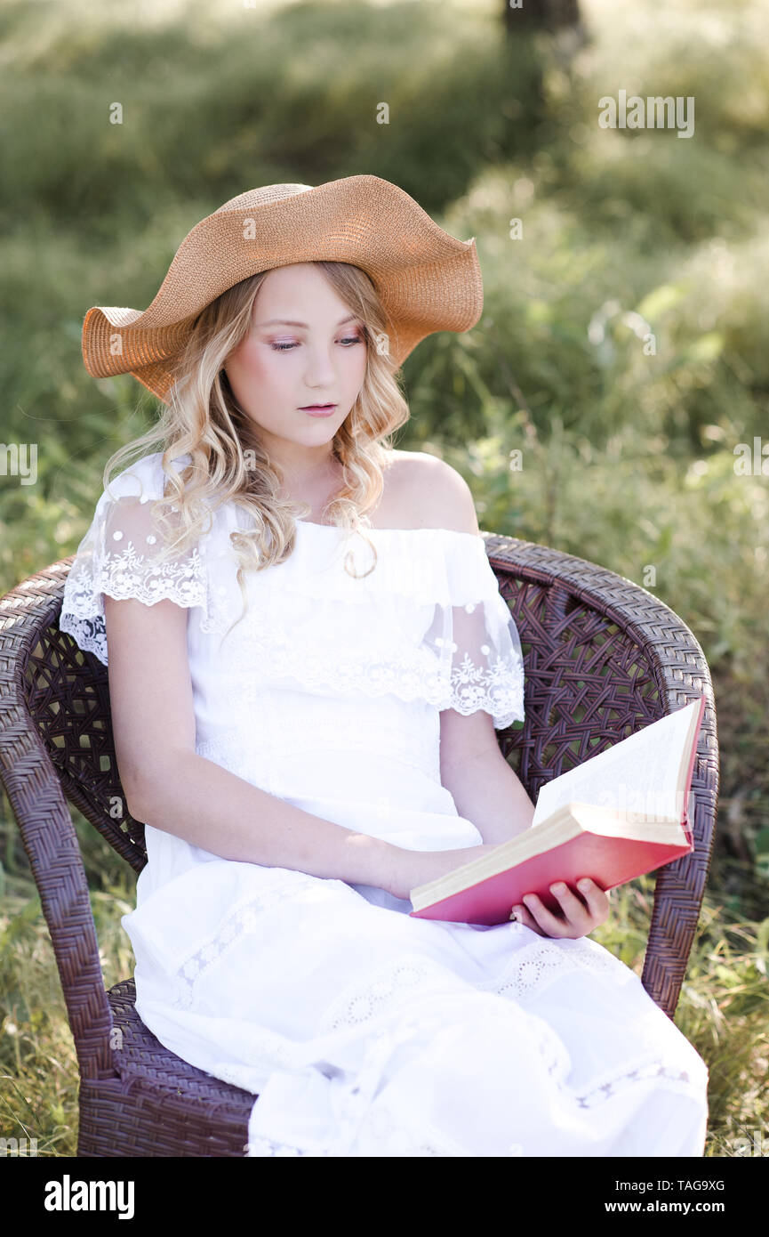 Beautiful Blonde Girl 15 16 Year Old Reading Book Sitting In Chair