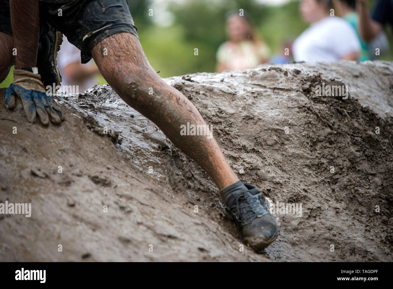 SOFIA, BULGARIA - JULY 7th 2018 - a mans leg is sliding over a muddy ...