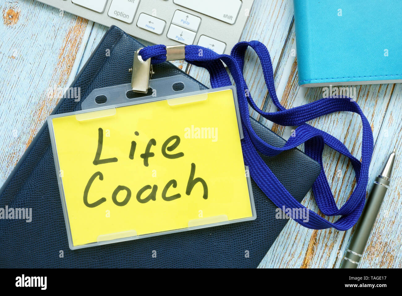 Life coach badge with keyboard on a wood Stock Photo - Alamy