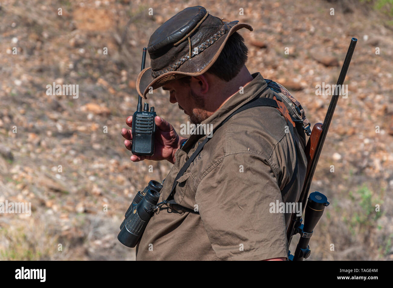 A hunter is communicating via two-way radio during a hunt in Namibia ...