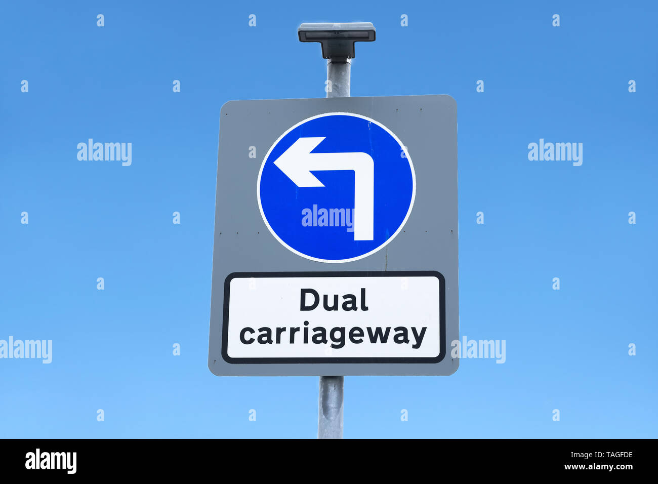 Dual carriageway road sign against blue sky Stock Photo - Alamy