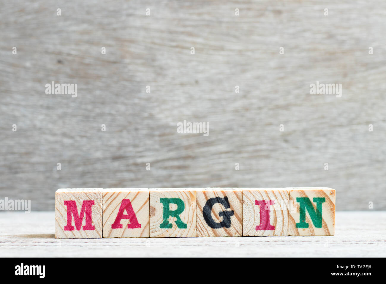 Letter block in word margin on wood background Stock Photo - Alamy